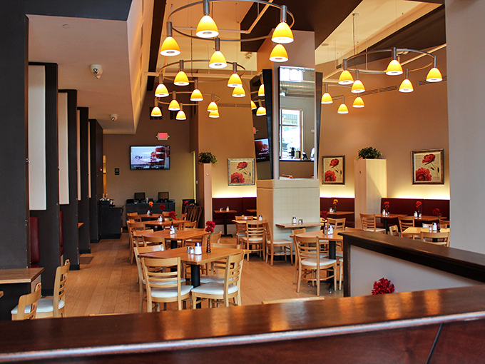 Warm pendant lighting casts a golden glow over wooden tables, creating that perfect "I could stay here all morning" ambiance.
