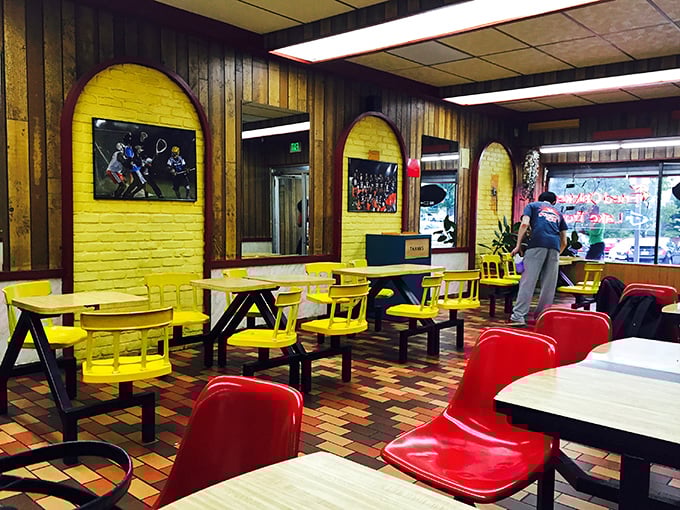 Yellow walls and red chairs create a cheerful diner atmosphere that says, "Stay awhile!" This isn't Instagram-bait decor—it's genuine Baltimore comfort.