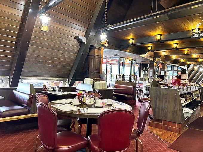 Wooden beams and red vinyl booths create that perfect diner atmosphere—like walking into your favorite aunt's cabin, if she happened to be a breakfast wizard.