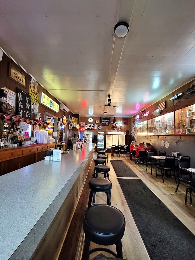 Classic tavern ambiance with wood-paneled walls and neon signs – the kind of place where everybody might not know your name yet, but they'll remember your order.
