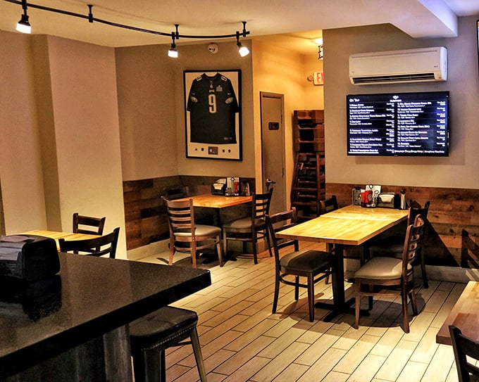 Eagles pride meets sandwich perfection in this cozy dining area. The framed jersey watches over patrons like a guardian angel of good taste.