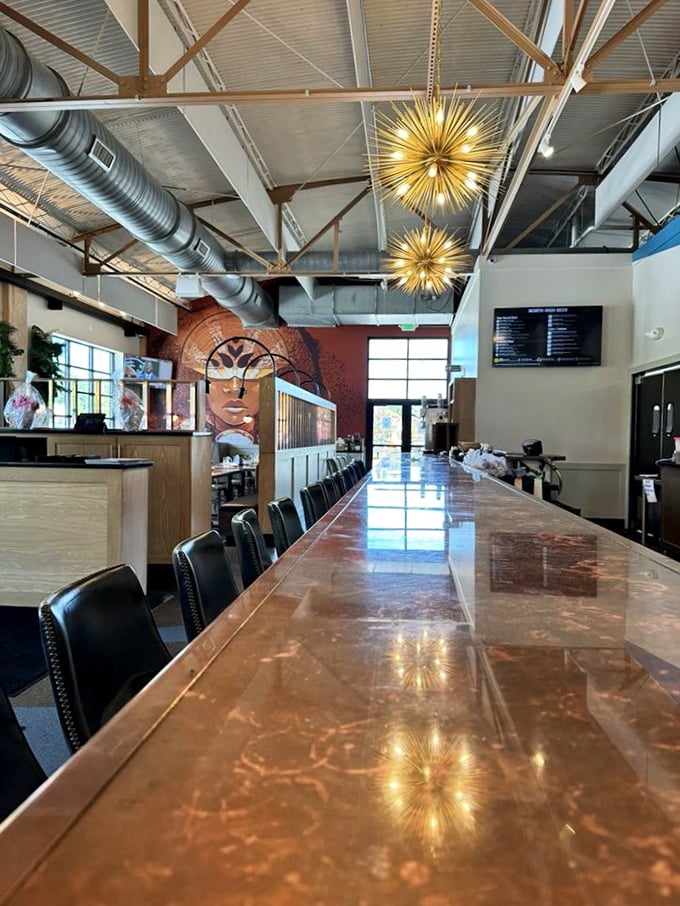 Industrial chic meets warm hospitality under those spectacular starburst chandeliers. That copper bar isn't just gorgeous—it's the stage for brewing magic.