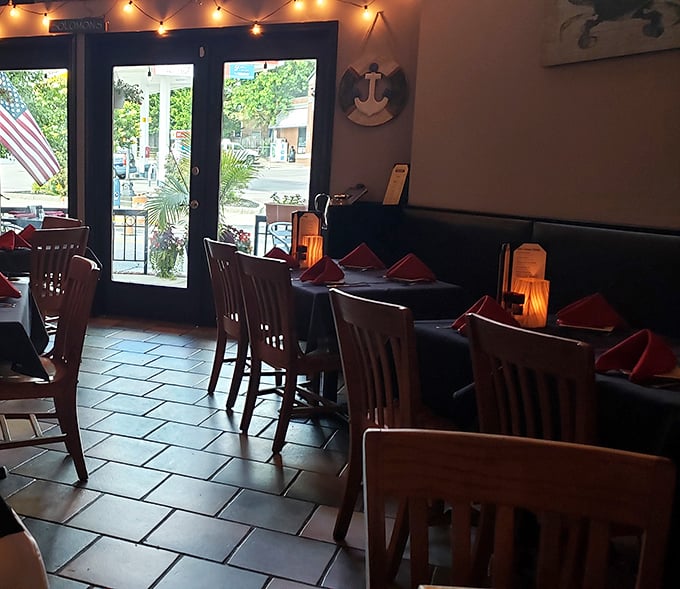 String lights cast a warm glow over wooden chairs and coral napkins—the perfect backdrop for seafood stories and second rounds.
