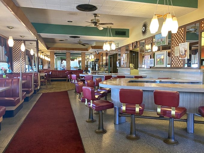 Red vinyl booths and swivel counter stools aren't retro by design—they're authentic survivors from an era when "social media" meant chatting with your neighbor at the counter.