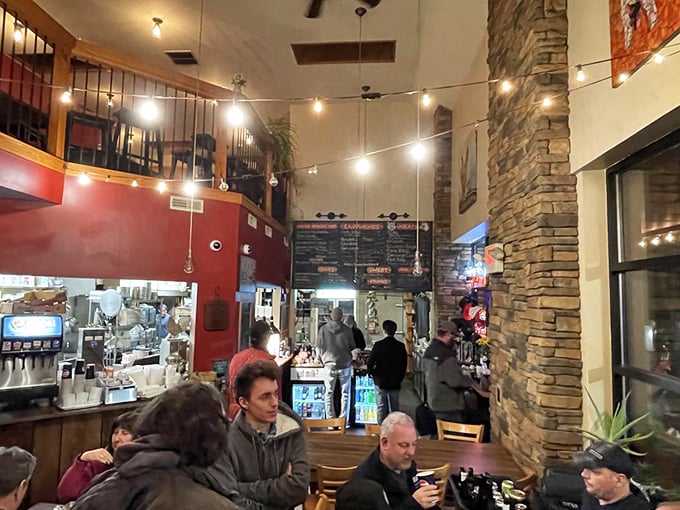 String lights dance overhead while stone walls create a rustic-meets-cozy vibe – the perfect backdrop for the serious business of barbecue appreciation.