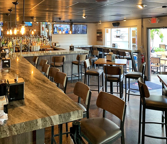 Pull up a seat at this inviting bar where the marble countertop gleams under warm lighting. The perfect spot to debate the merits of dry rub versus sauce.
