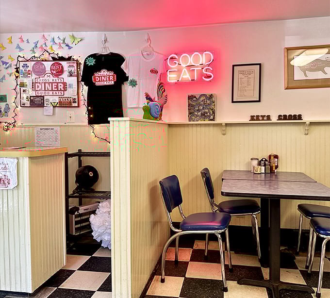 Retro vibes and a neon "GOOD EATS" sign that doesn't lie. This classic black-and-white checkered floor has witnessed countless breakfast epiphanies.