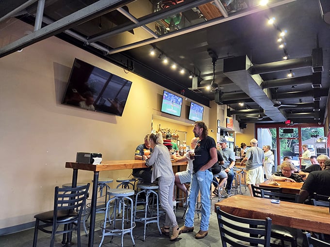 Inside, industrial-chic meets comfort with exposed ceiling elements and warm wood tables—the perfect backdrop for the smoky drama about to unfold on your plate.