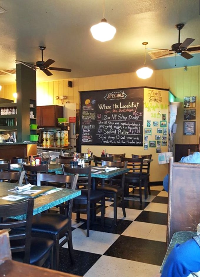 Classic black and white checkered floors, chalkboard specials, and ceiling fans spinning lazily overhead—this isn't just a diner, it's a time machine with better food.