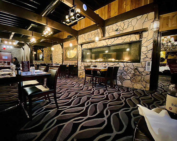 Step into a time capsule of classic steakhouse ambiance—stone walls, wooden beams, and that distinctive wavy carpet that somehow works perfectly. Dim lighting sets the mood for serious meat consumption.