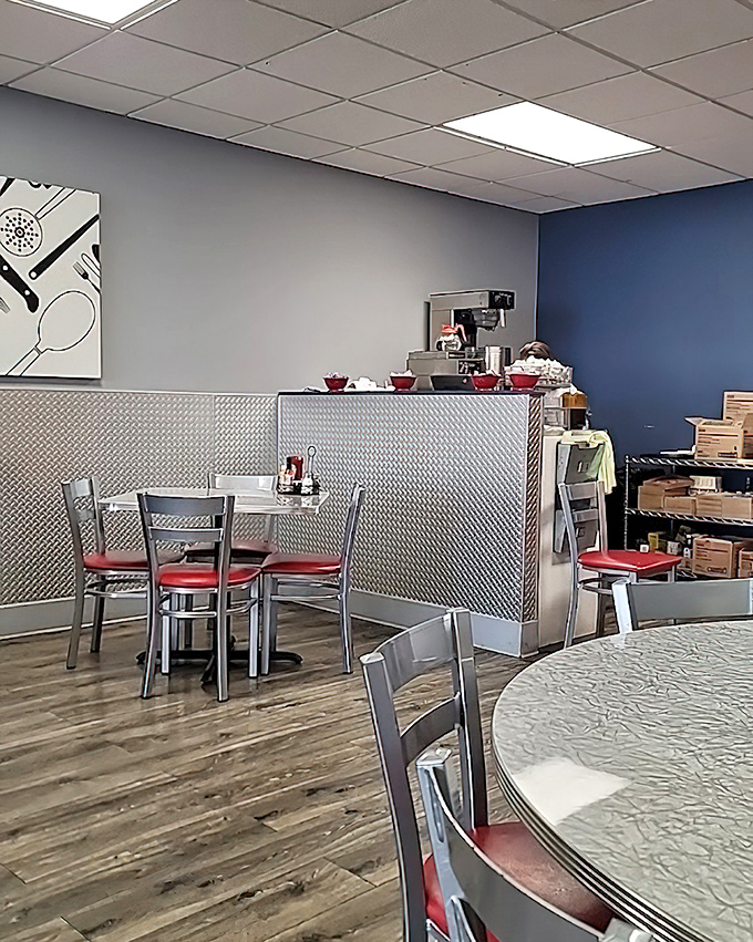 Modern meets classic in this thoughtfully designed space. Metal dividers create semi-private dining nooks while red seat cushions pop against neutral walls.