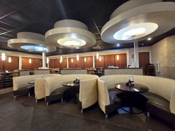 Modern circular booths create intimate dining islands in a sea of culinary possibilities. The contemporary ceiling fixtures cast a warm glow that says "stay awhile."