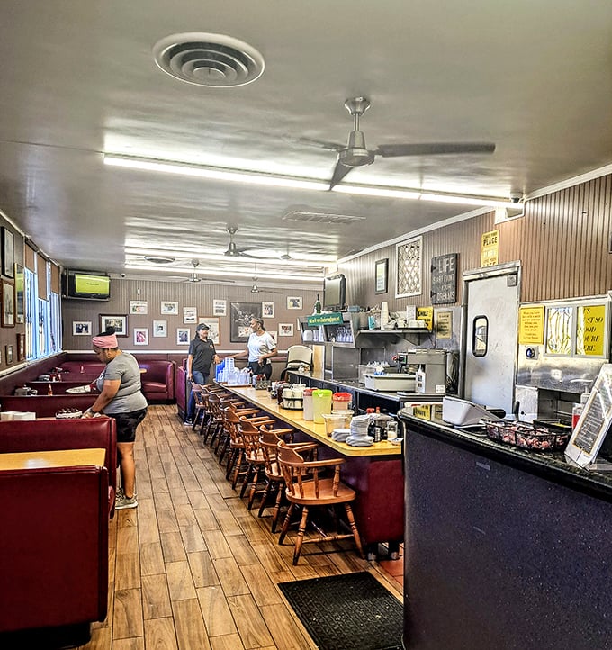 Step into this cozy time capsule where red booths and friendly faces create the perfect breakfast sanctuary atmosphere.