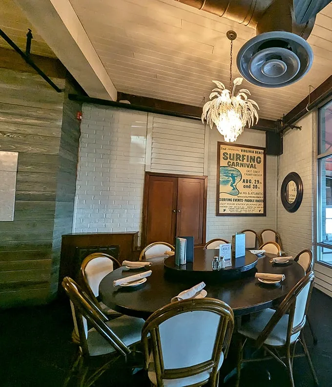 Private dining perfection: Vintage surfing posters, elegant chandeliers, and white-painted brick create an intimate space where memories are made between bites.