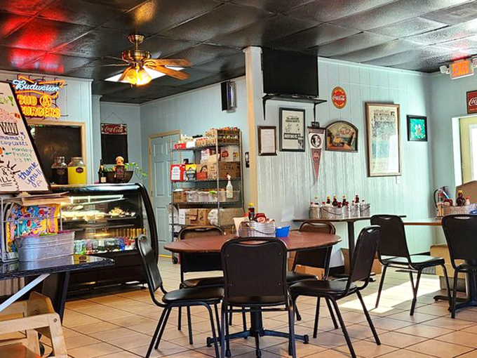 Inside, nostalgia meets comfort with light blue walls, vintage signs, and a display case promising sweet rewards for those who save room.