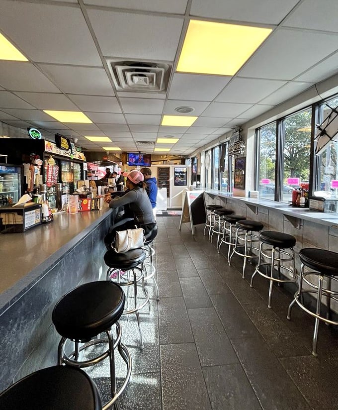 Counter culture at its finest—where spinning stools and fluorescent lighting set the stage for cheesesteak magic to unfold before your very eyes.