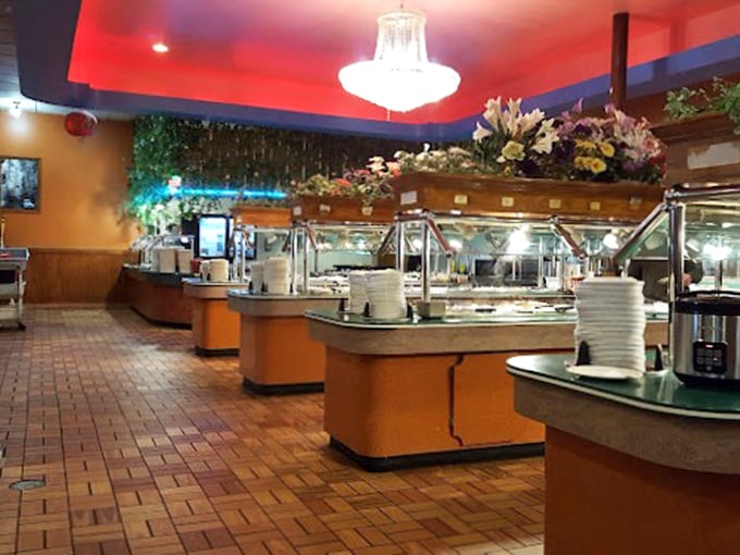 Crystal chandeliers meet brick-patterned floors in this dining room where the buffet islands stand like monuments to the democracy of appetite.
