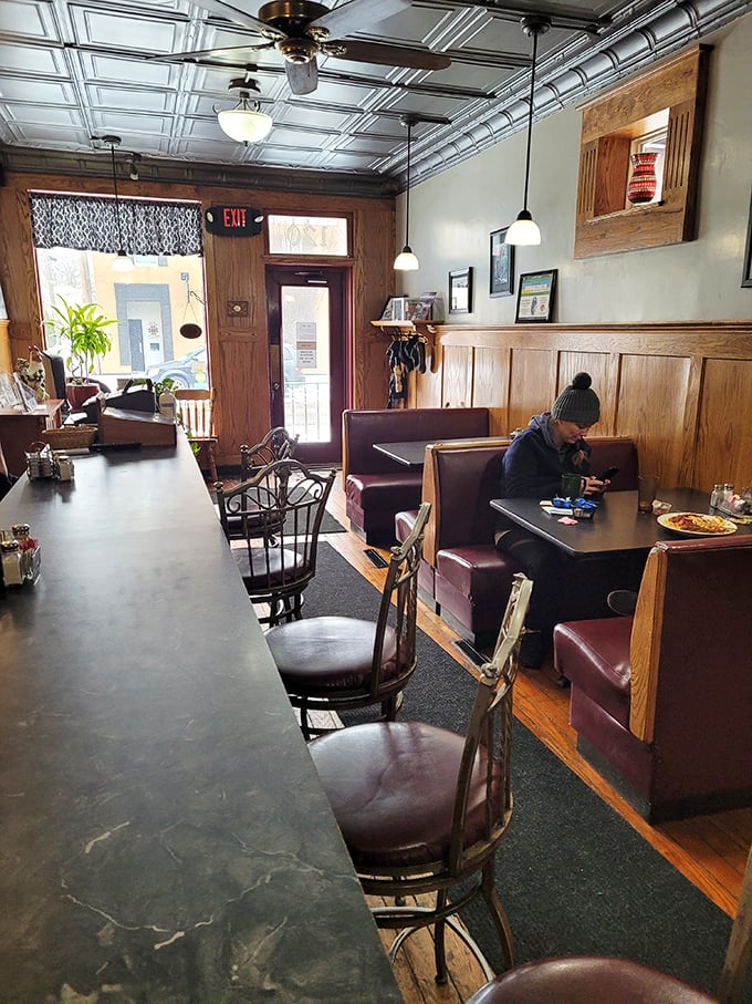 Step inside and time slows down. The pressed tin ceiling, wooden wainscoting, and burgundy booths aren't trying to be retro—they simply never left.
