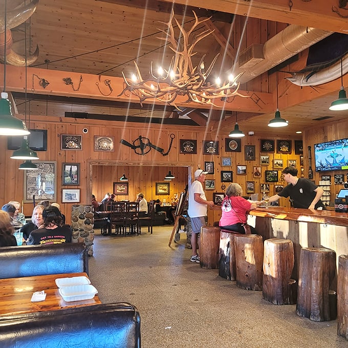Step inside and time slows down – knotty pine walls, antler chandeliers, and log stools create the perfect backdrop for food that tastes like childhood memories.
