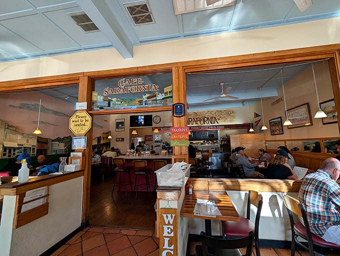 Step inside to a classic diner atmosphere with light blue ceiling beams, wooden booths, and that unmistakable buzz of locals and visitors breaking bread together.