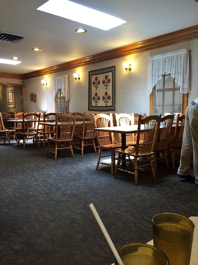 2. Wooden chairs that have witnessed countless family gatherings, quilts on walls, and lace curtains—this dining room feels like Grandma's house, if Grandma could cook for 100.