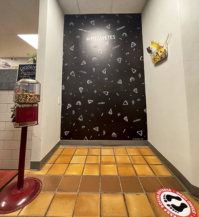 The Instagram-worthy pizza slice wall isn't just for show—it's the perfect backdrop for the inevitable "before" photos. The "after" photos never happen because, well, pizza.