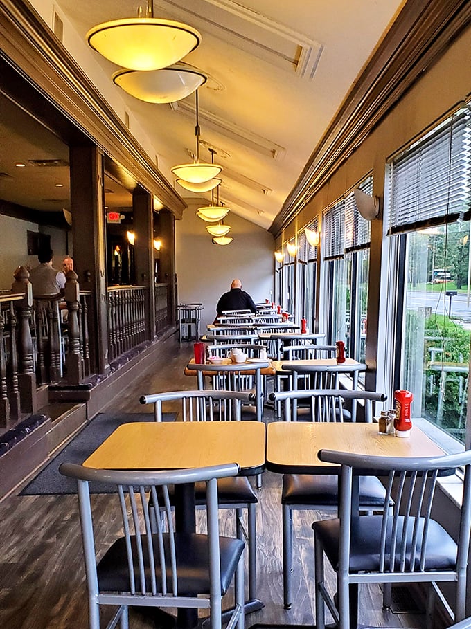 Morning light streams through windows lining this cozy dining area. The perfect setting for contemplating life's big questions over coffee and pancakes.