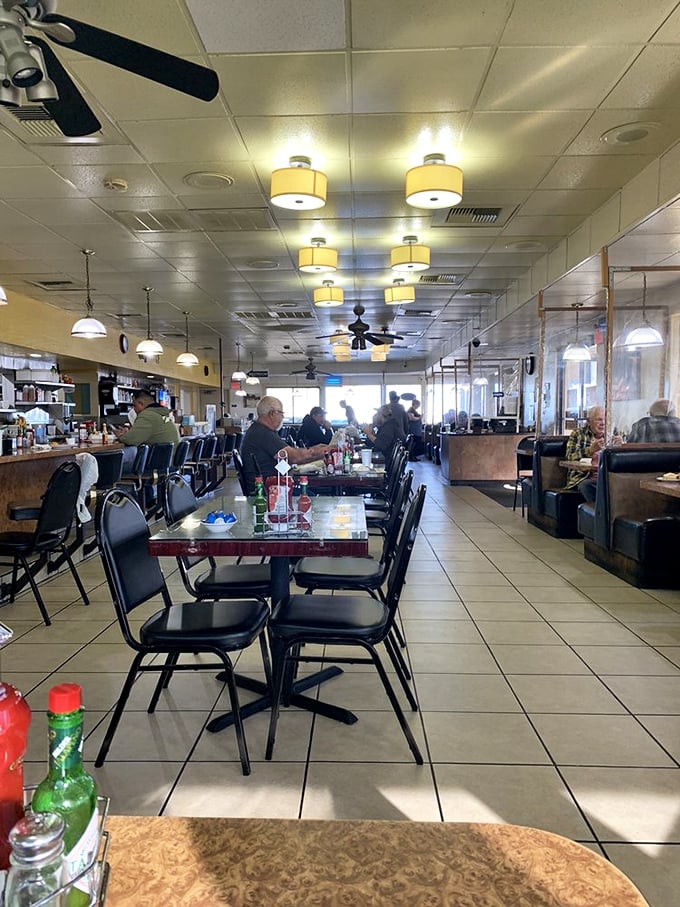 Inside, ceiling fans lazily spin above a sea of tables where breakfast dreams come true. This is democracy in dining—everyone equal before the pancake.