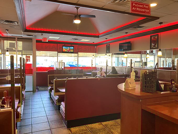 Red booths and warm lighting create that perfect "everybody knows your name" vibe. The kind of place where comfort arrives before your food does.
