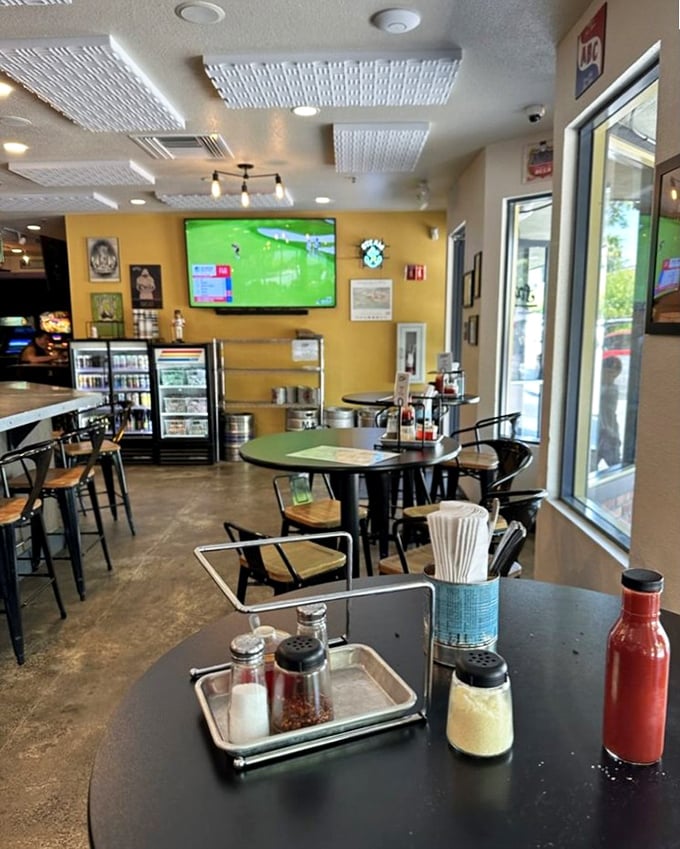 Yellow walls and sports on TV create that perfect neighborhood vibe—where strangers become friends over shared cheers and cold beers.