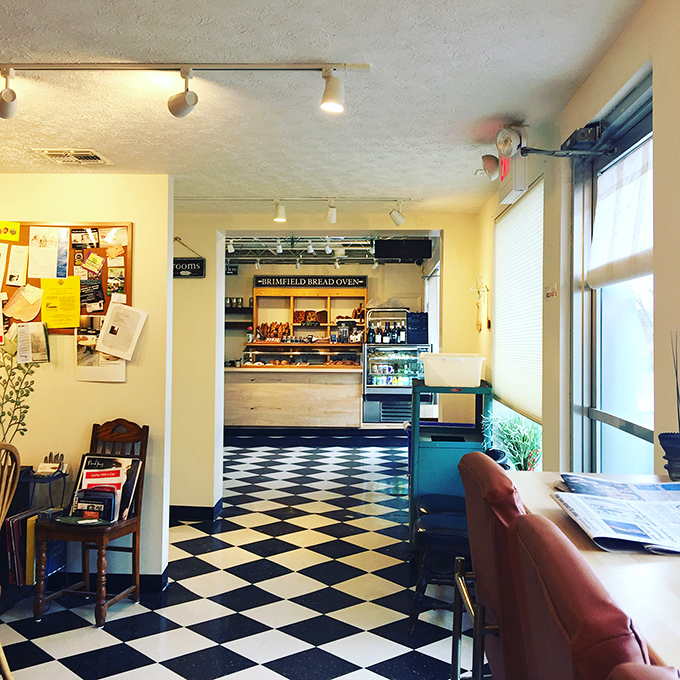 That classic black and white checkered floor isn't just nostalgic—it's the runway where carb dreams take flight. The bakery's warm interior invites you to linger and indulge.