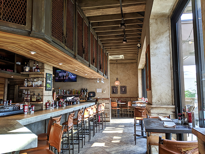 The architectural soul of Flip Side: soaring ceilings, warm wood tones, and leather bar stools that practically whisper "stay awhile" to weary shoppers.
