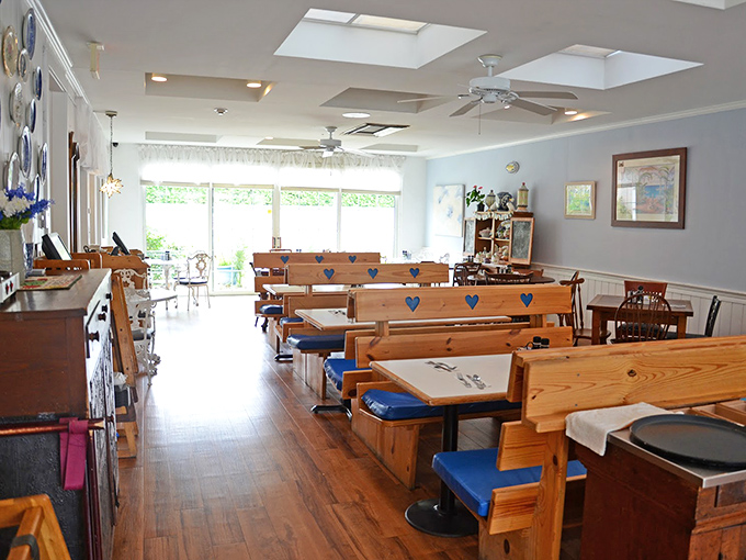 Wooden booths with heart cutouts and blue cushions create that rare atmosphere where comfort meets character, bathed in natural Florida sunshine.