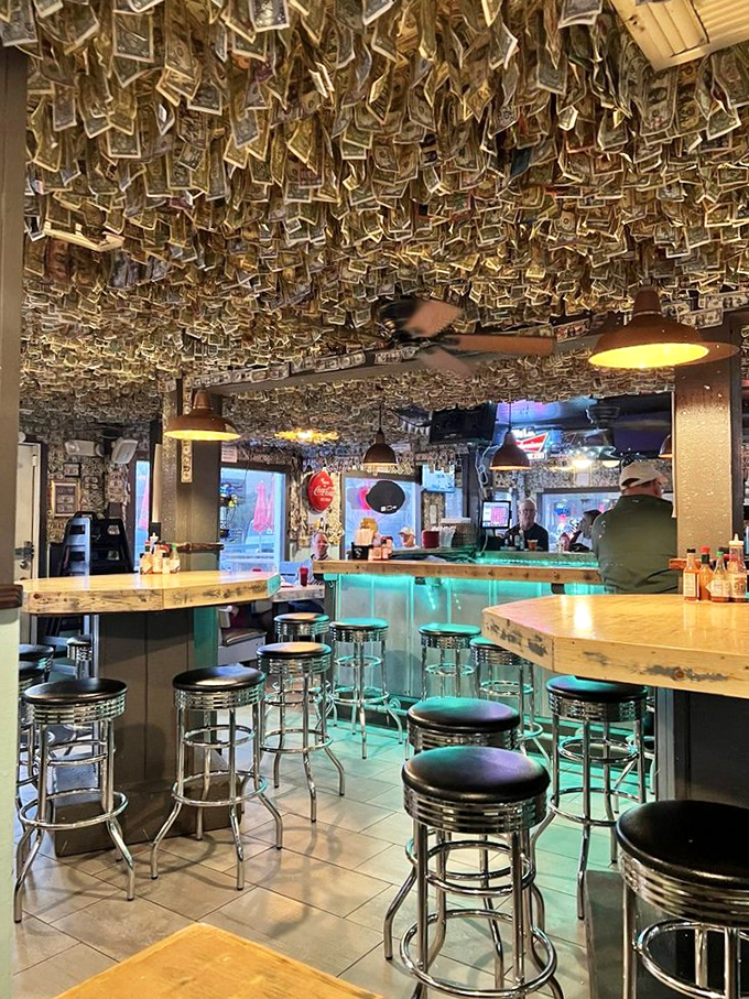 Money talks, but at Shuckums it also decorates. Thousands of dollar bills cling to the ceiling like a reverse rainstorm of cash, creating the world's most lucrative wallpaper.