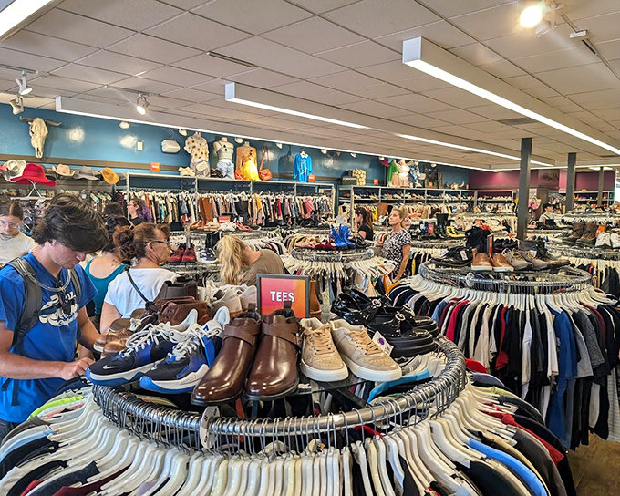 Circular racks create a treasure hunter's paradise where vintage gems and contemporary finds coexist in perfect harmony. Fashion archaeology at its finest!