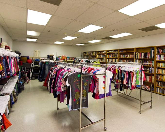 Children's clothing organized with military precision next to a literary goldmine. Two hobbies for the price of one—dress the kids, feed your mind.
