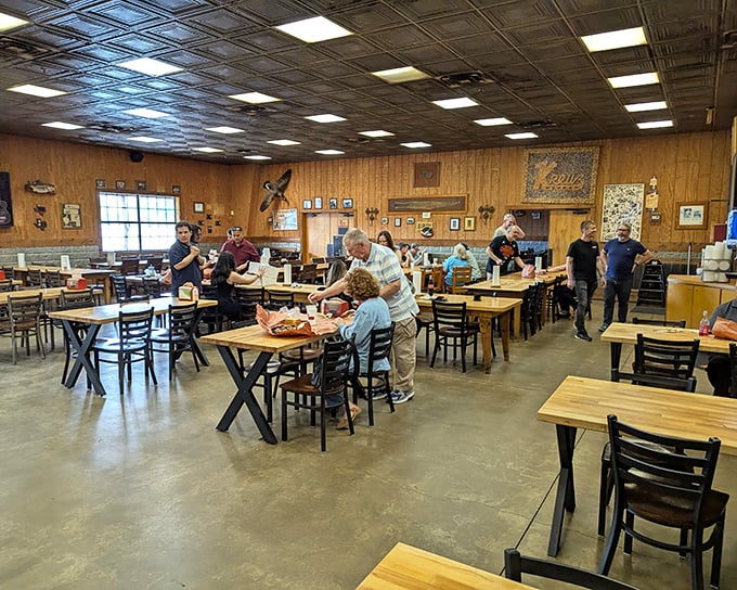 Democracy in dining—wooden tables where ranchers, tech bros, and barbecue pilgrims gather in reverent silence, united by the universal language of smoked meat.