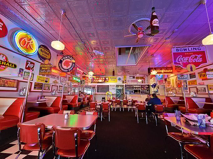 Step inside and the neon glow bathes you in a warm, retro embrace. This isn't decoration—it's a full-immersion time machine with comfort food as your destination.