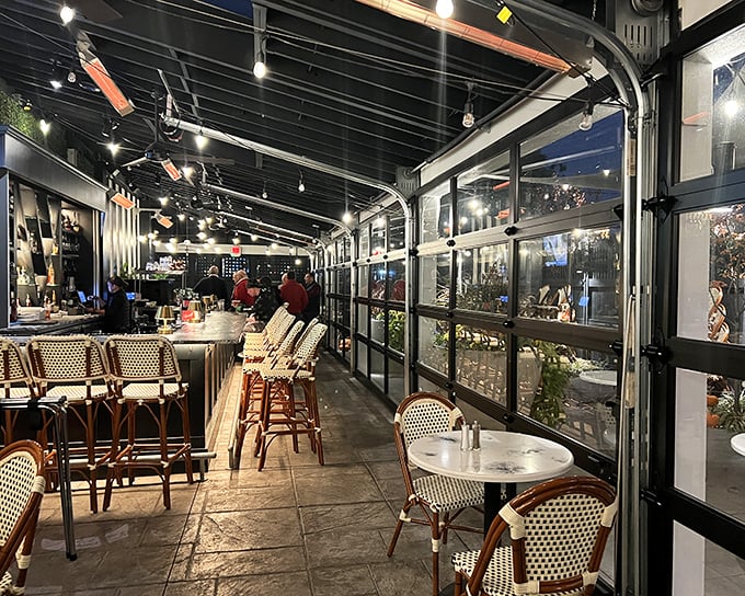 Inside, the elegant bar area beckons with bistro seating and ambient lighting. This isn't just dining—it's time travel with cocktails.