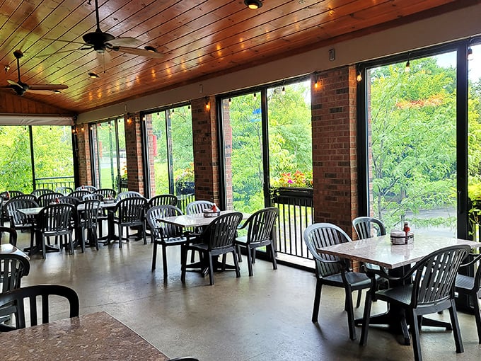 Sunlight streams through the enclosed patio, creating the perfect backdrop for comfort food conversations and memory-making meals with loved ones.
