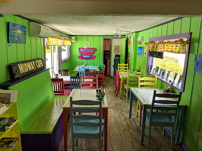 Rainbow-hued chairs gather around mosaic tables like a committee of joy plotting your perfect breakfast in this whimsical lime-green interior.