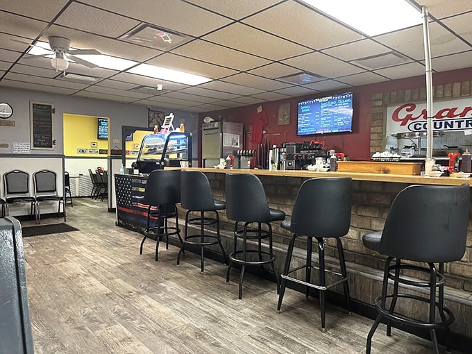 Counter seating: where breakfast dreams and coffee refills flow freely. That American flag detail tells you this place takes its comfort food seriously.
