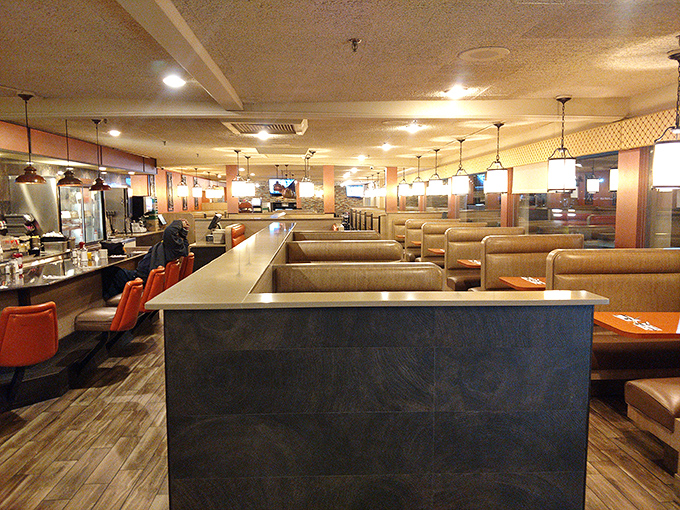 Classic diner chic at its finest—tan vinyl booths, counter seating, and warm lighting create that perfect "everybody knows your name" atmosphere where breakfast dreams come true.