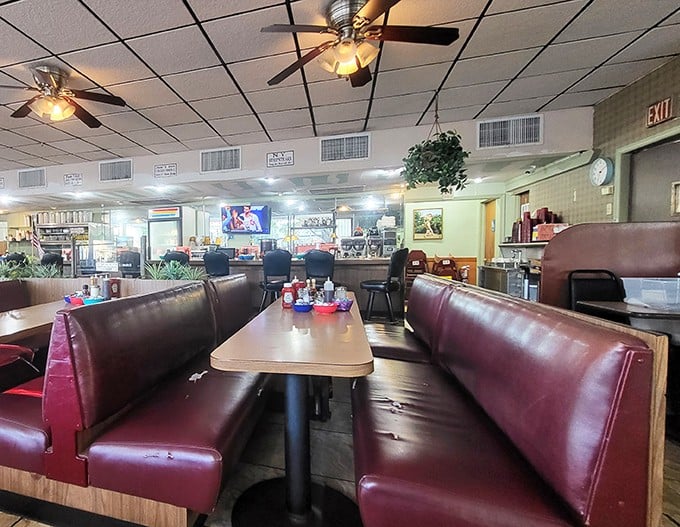 Classic burgundy vinyl booths that have cradled countless Miami locals through decades of breakfast conversations. The ceiling fans spin stories overhead.