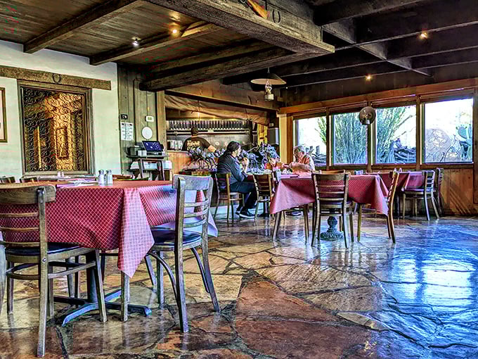Inside, wooden beams and stone floors tell stories of countless Arizona evenings, while red checkered tablecloths promise homestyle comfort without pretension.