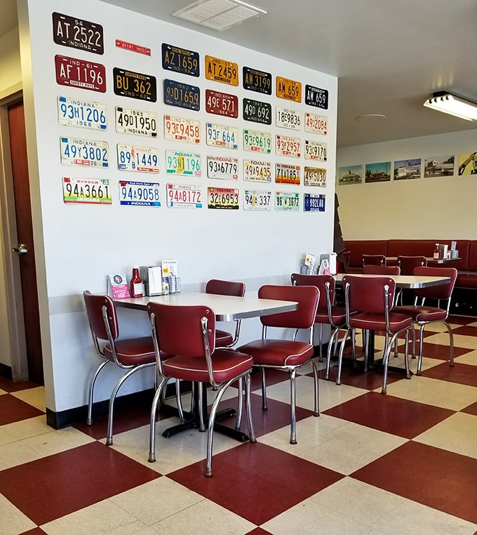 License plates tell stories of journeys past, while cherry-red vinyl booths invite you to create new memories. Checkerboard floors complete this symphony of nostalgia.