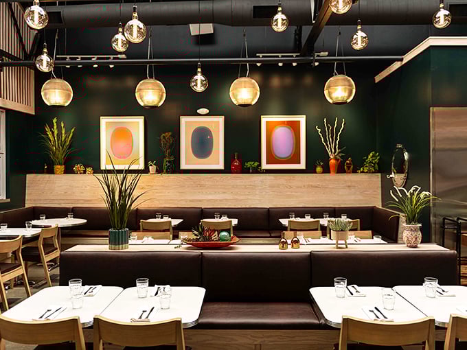 Modern meets nostalgic in Poole's elegant interior, where pendant lighting casts a golden glow over conversations worth remembering.