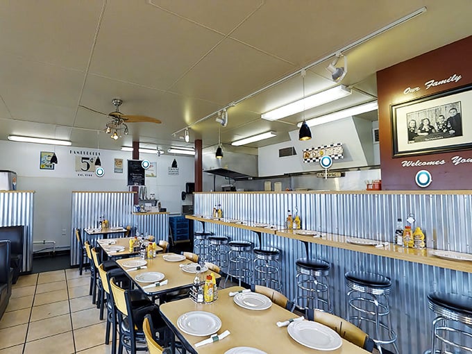 Classic Americana comes to life with corrugated metal wainscoting and chrome-legged stools. This isn't retro-themed décor—it's the real deal that never went out of style.