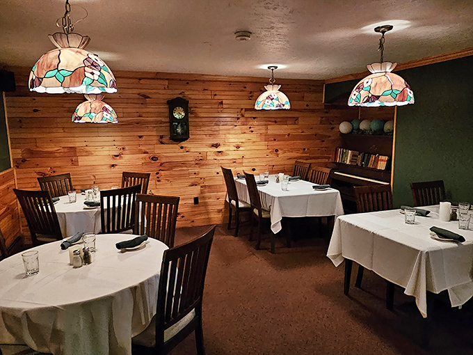 Tiffany-style lamps cast a warm glow over pine-paneled walls, creating the perfect atmosphere for important life decisions—like ribeye or filet mignon?
