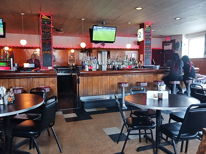 Warm wood paneling, classic bar stools, and checkered floors create that perfect neighborhood joint vibe. The kind of place where everybody might not know your name—yet.